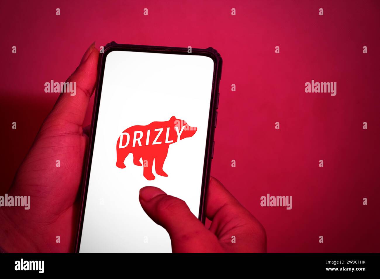 Hands close up. This photo illustration shows the logo of alcohol ...