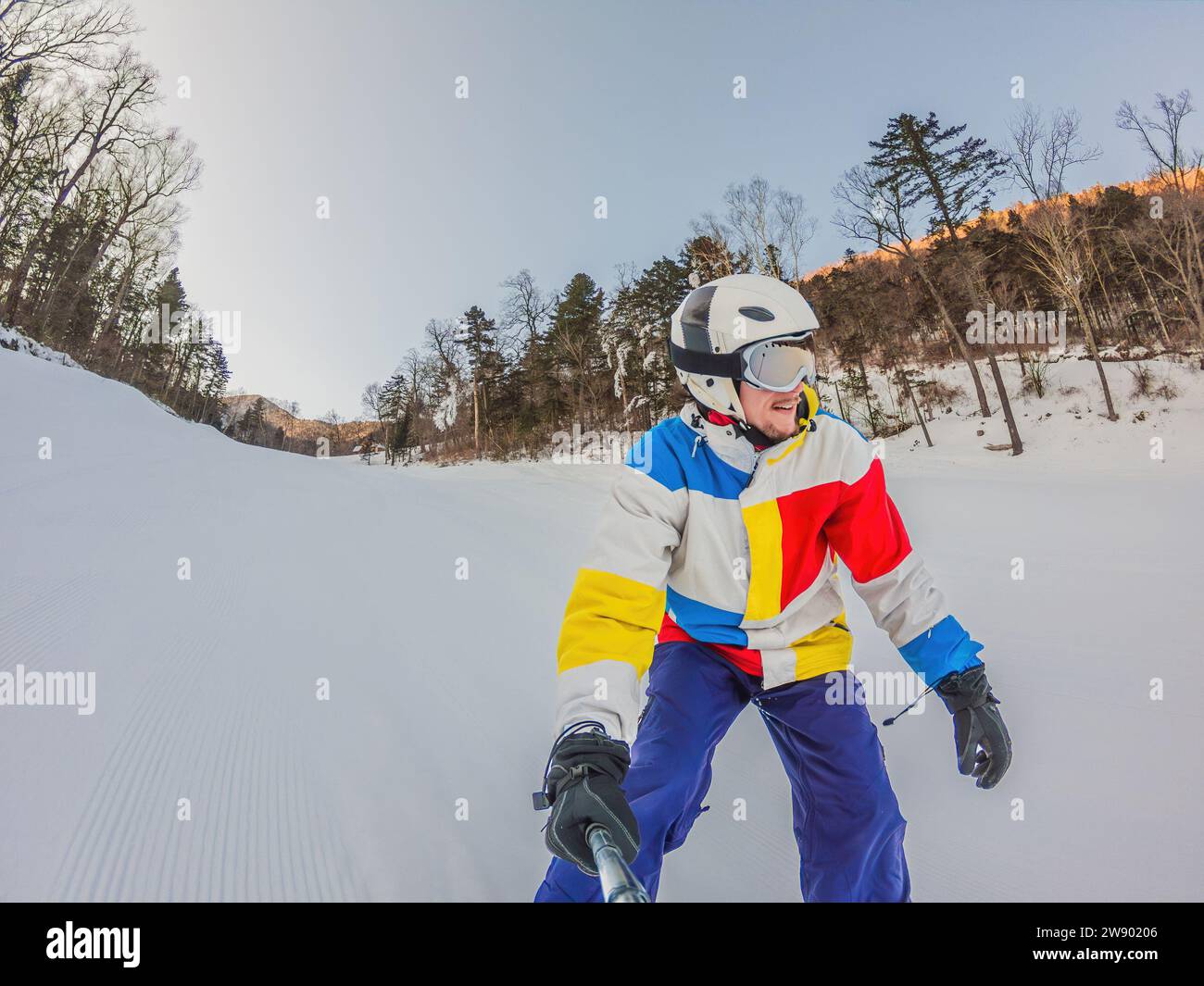 A daring man conquers snowy slopes with style, showcasing skill and ...