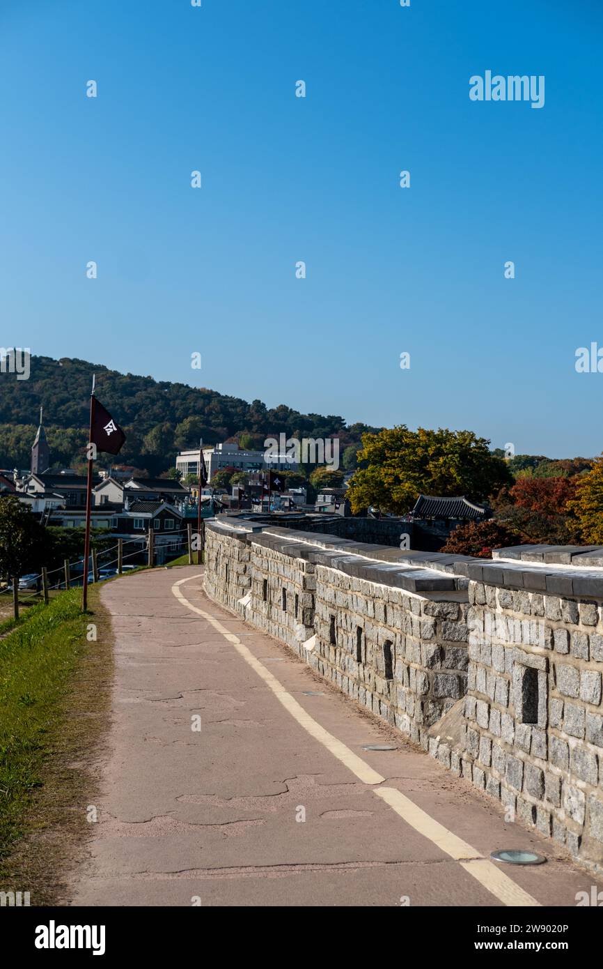 Suwon Hwaseong Fortress Wall, with the park view during autumn. The ...