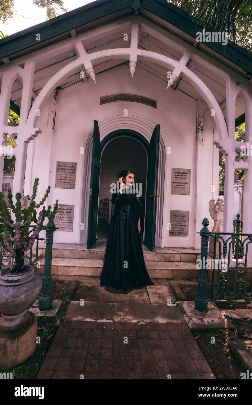 a witch in an all black dress and scary makeup was standing at the ...