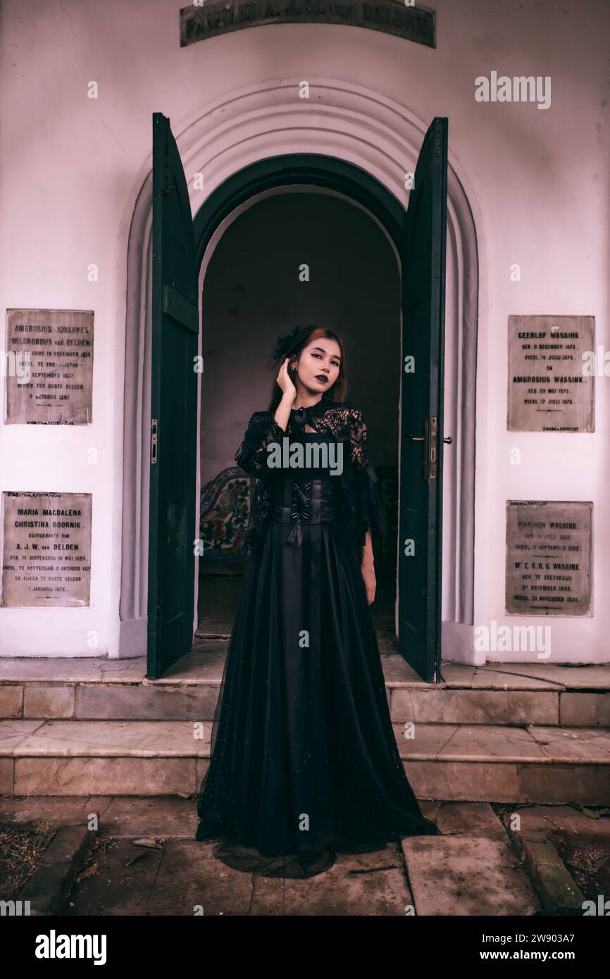 a witch in an all black dress and scary makeup was standing at the ...