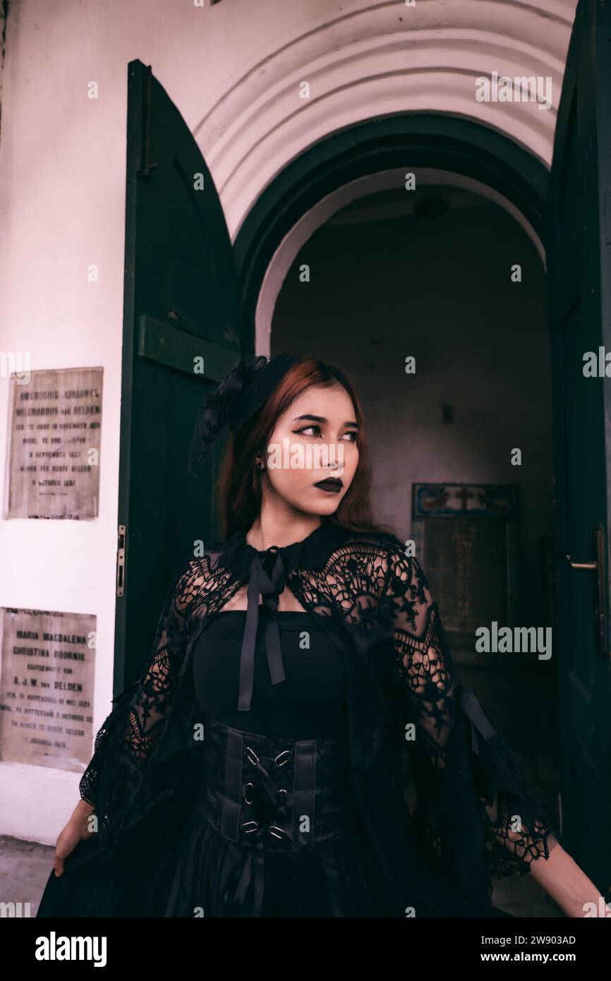a witch in an all black dress and scary makeup was standing at the ...