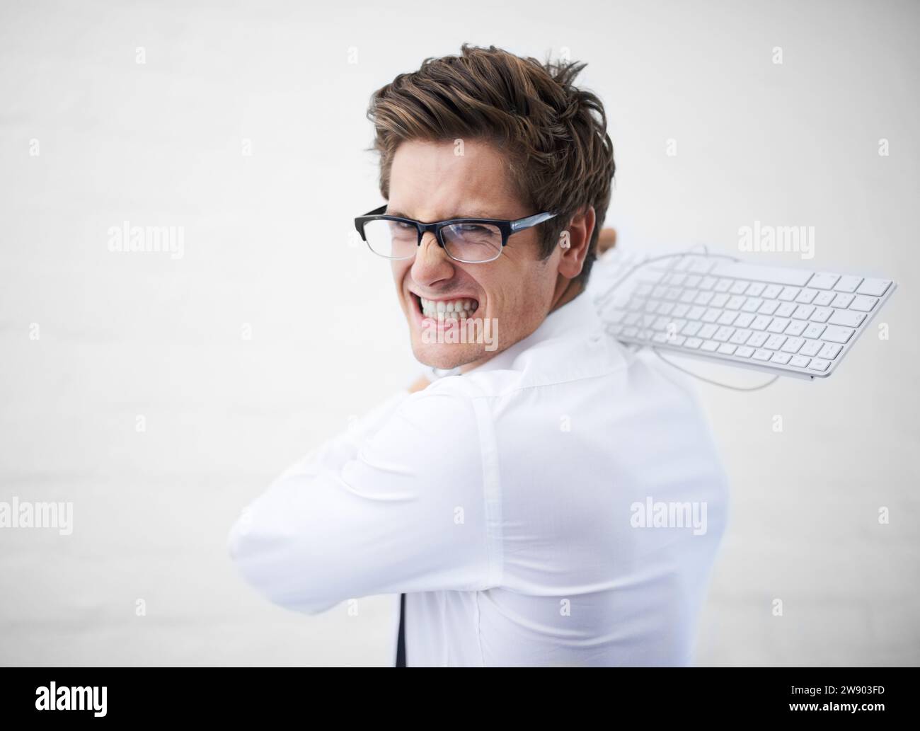 Man, angry and hitting with keyboard, boss and portrait to employee for ...