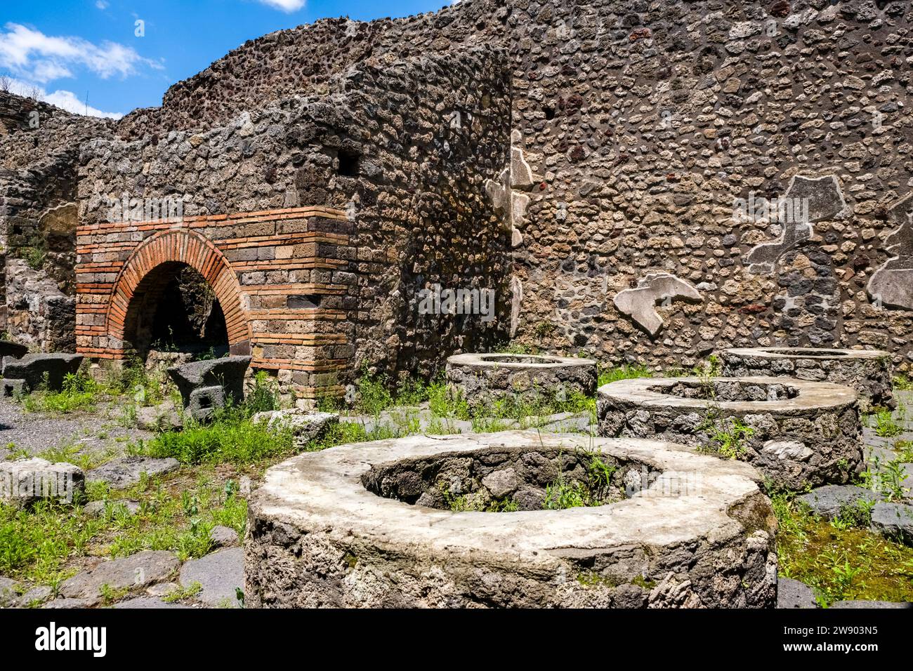 Ruins of the Pistrinum in the archaeological site of Pompeii, an ...