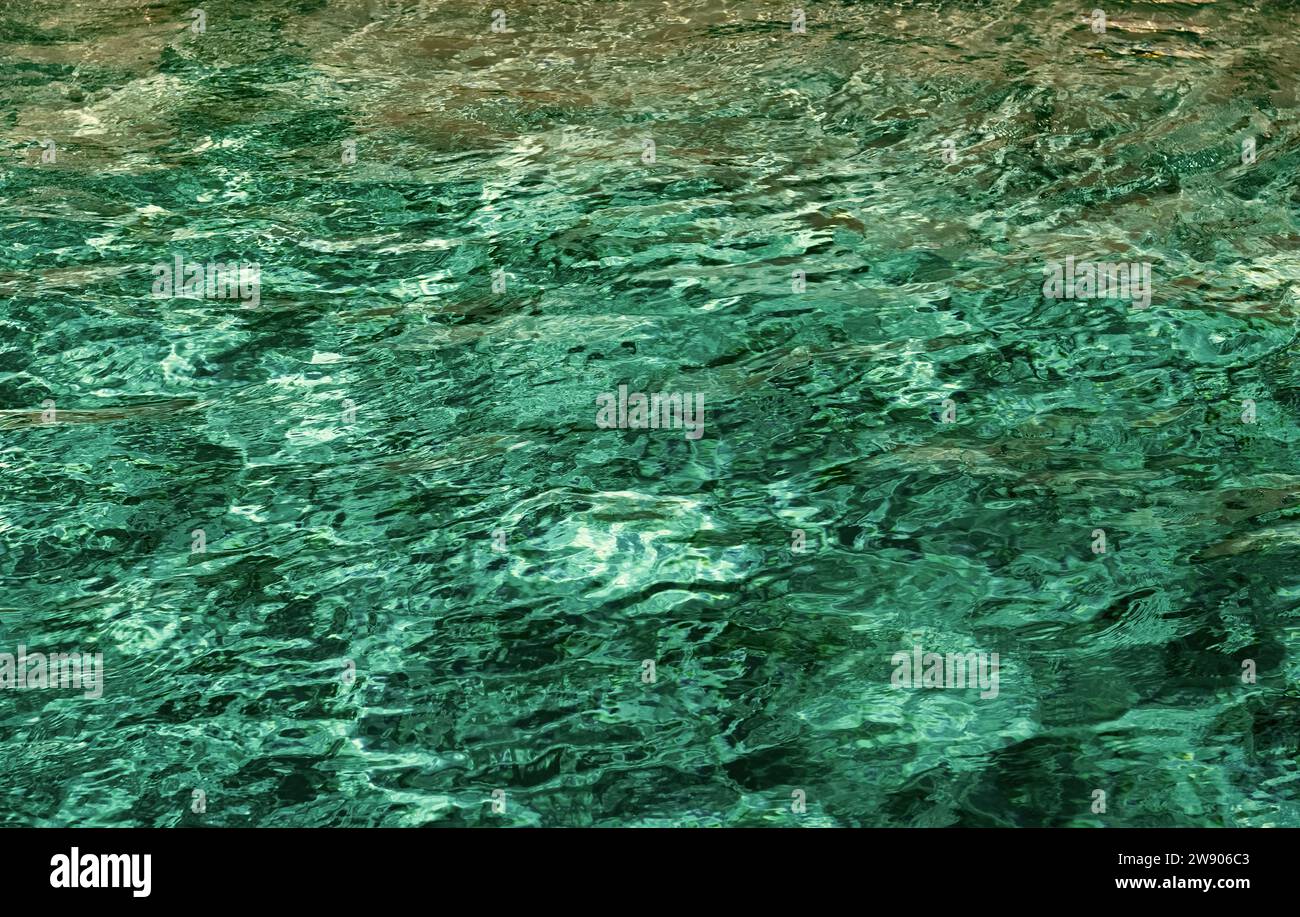 defocused summer pool summertime background with ripples. defocused ...