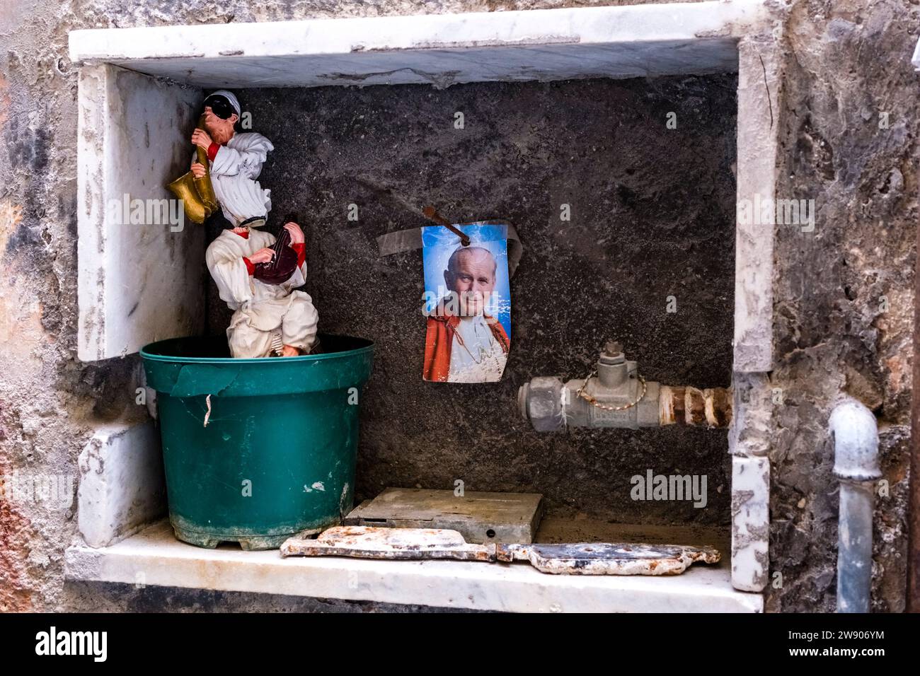 A water pipe, a plastic bucket, two small broken sculptures of ...