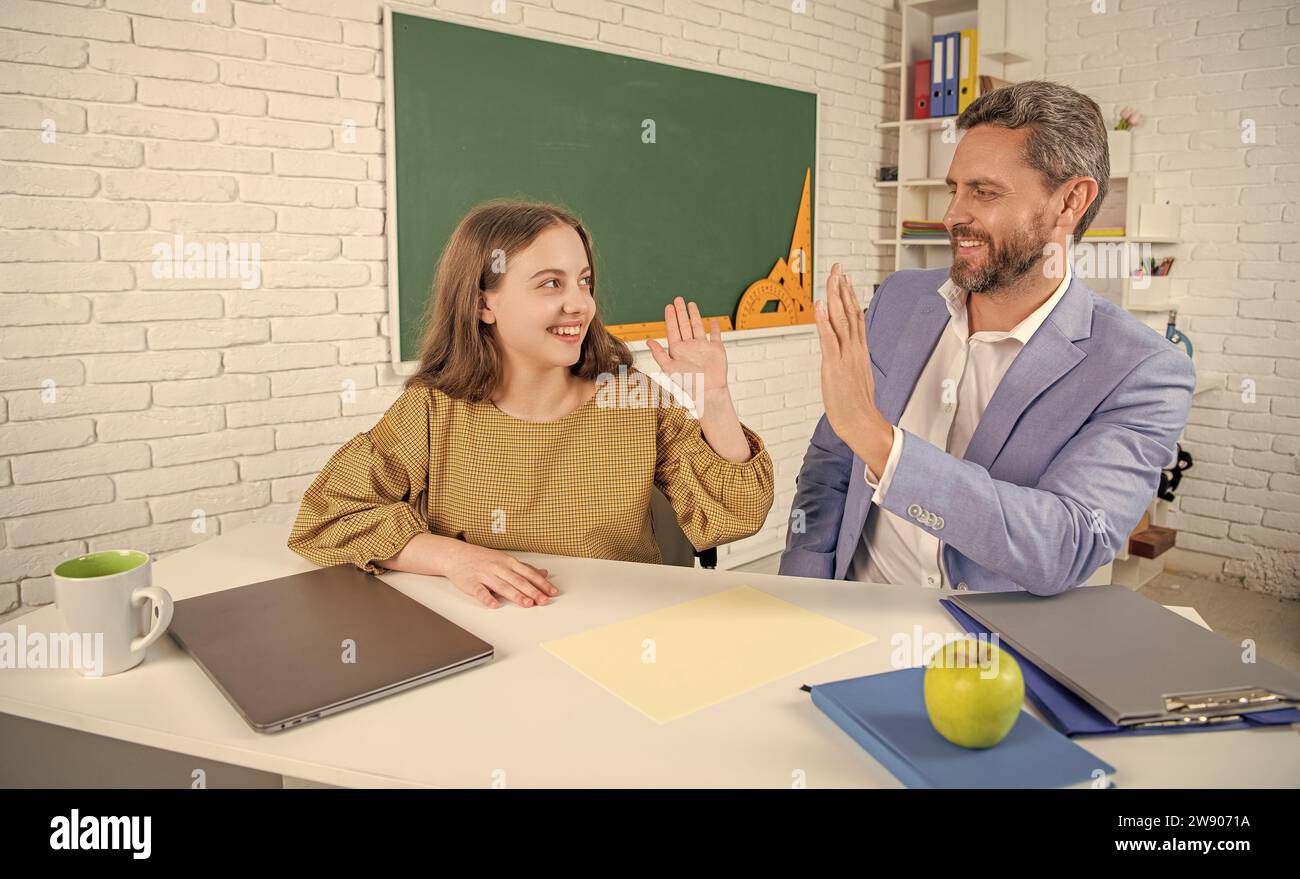 glad child study in classroom with tutor Stock Photo - Alamy