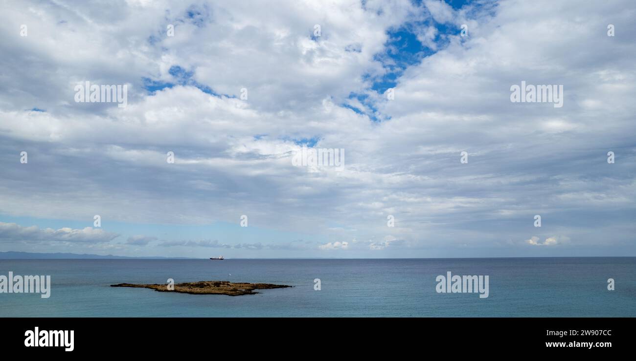 Drone scenery of deserted island in the ocean. Cloudy sky over sea ...