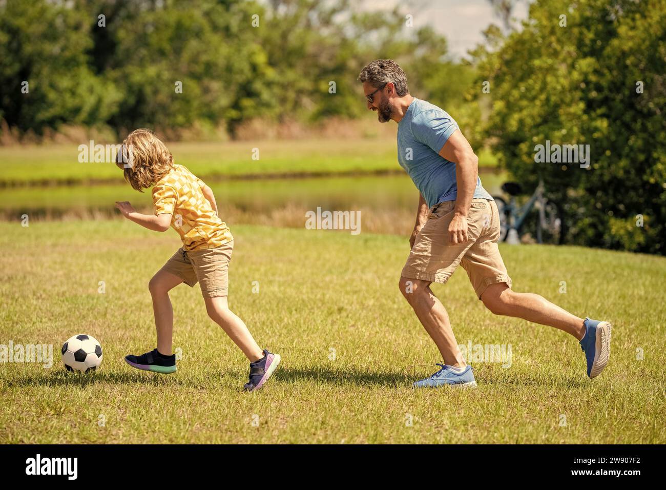 adventures between father and son. Active father son playing football ...