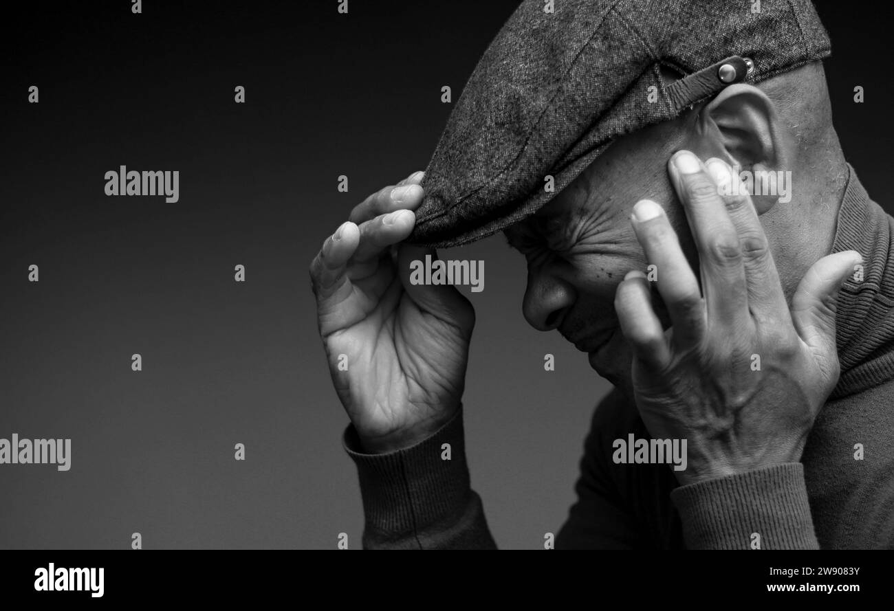 deafness suffering from hearing loss on grey black background with ...