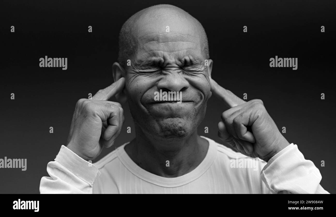 deafness suffering from hearing loss on grey black background with ...