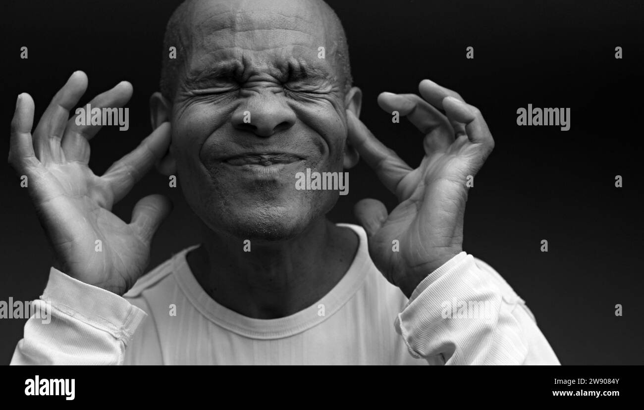 deafness suffering from hearing loss on grey black background with ...