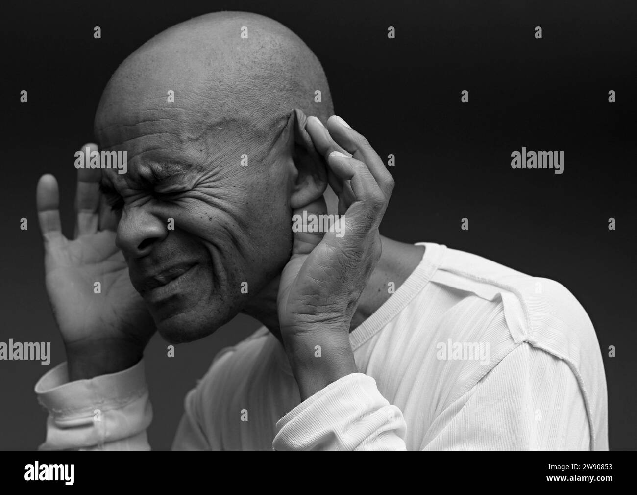 deafness suffering from hearing loss on grey black background with ...