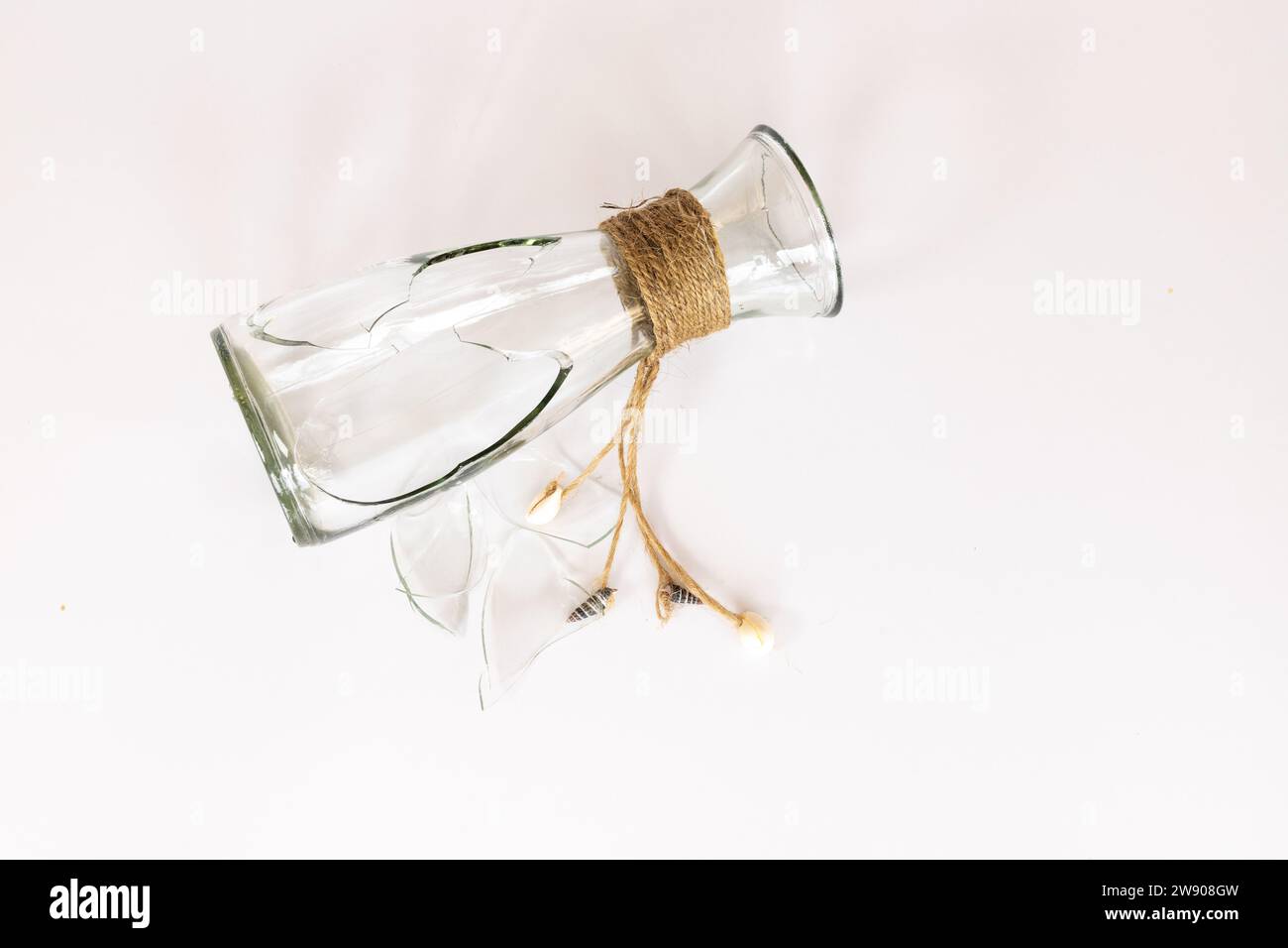 Transparent decorative glass vase shattered on white isolated ...