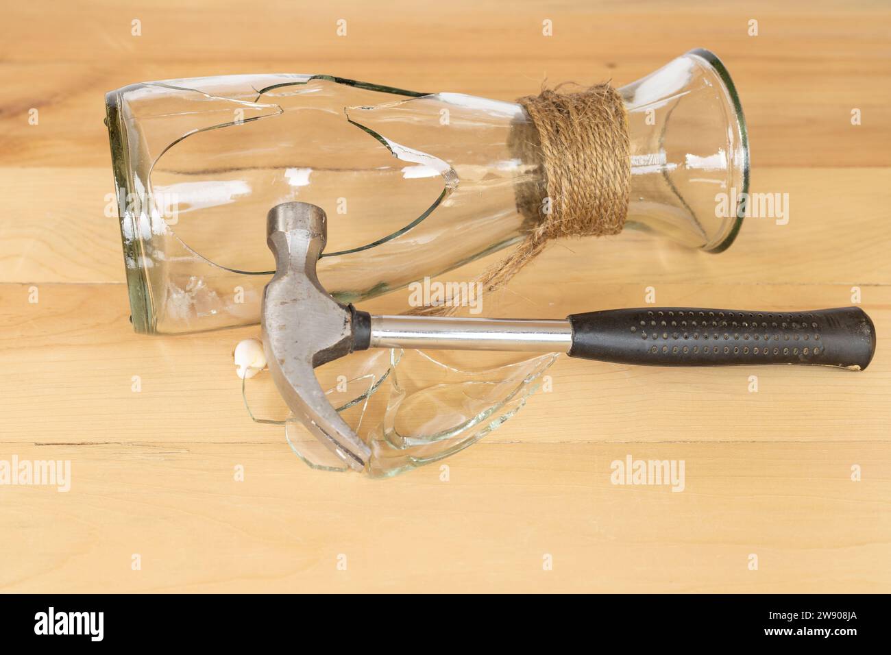A glass bottle hit with a metal hammer Stock Photo - Alamy
