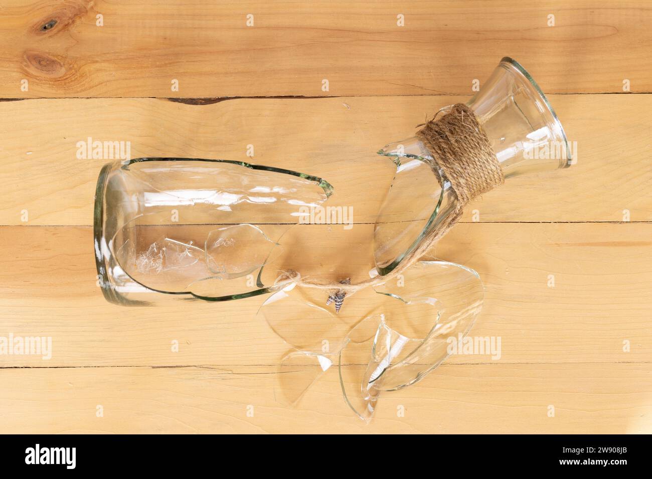 Broken glass vase with decomposed shards of glass on a black background ...