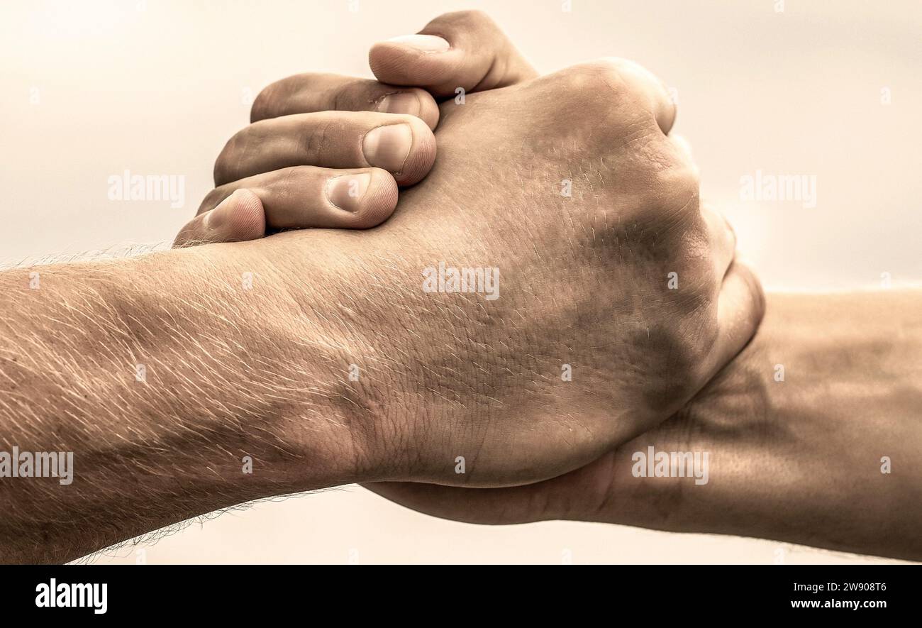Friendly handshake, friends greeting, teamwork, friendship. Rescue, helping gesture or hands ...
