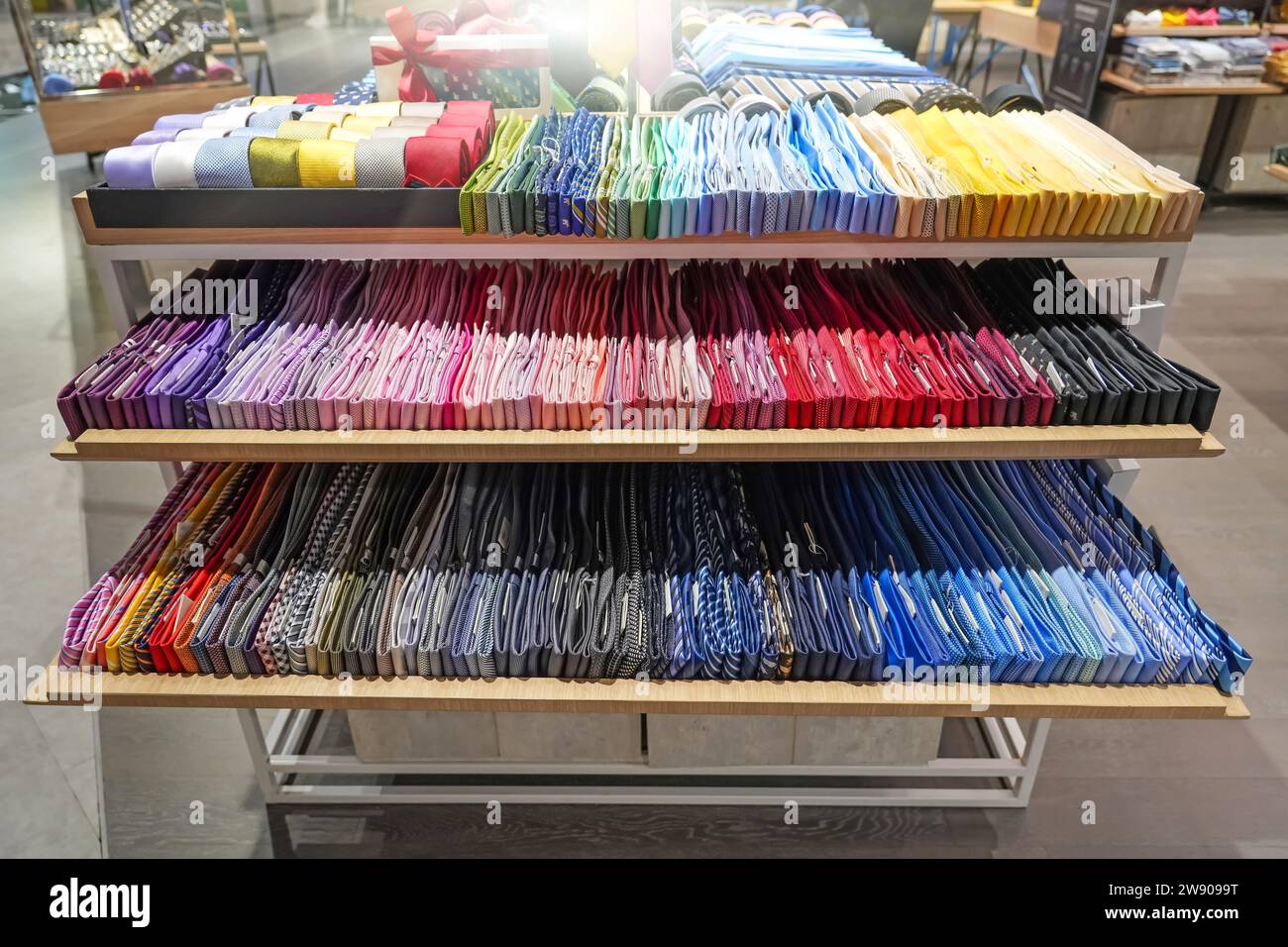 Counter with many expensive ties of various colors assortment of choice ...