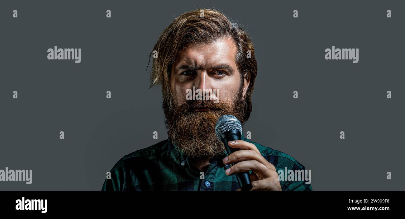 Bearded man singing with microphone. Male singing with a microphones ...