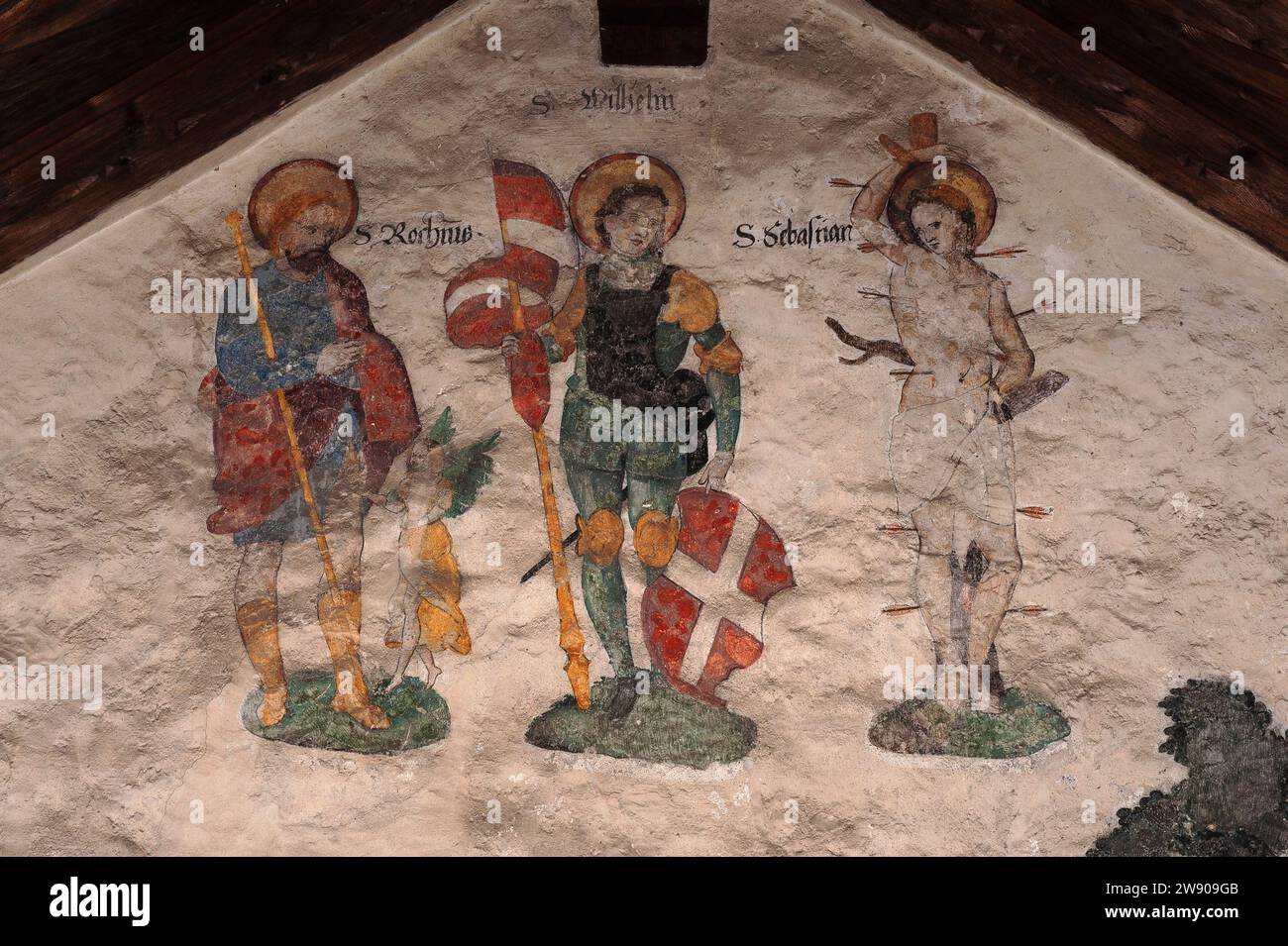 Three male saints in frescoes painted in 1588 on the front of a chapel ...