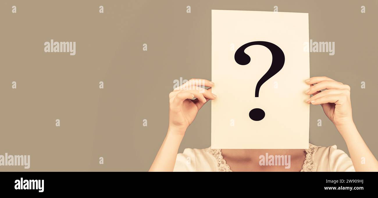 Woman holding interrogation symbol in front of her face. Female ...