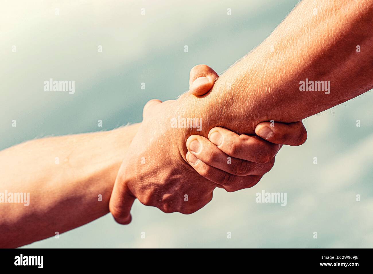 Two hands, helping arm of a friend teamwork. Helping hand outstretched ...