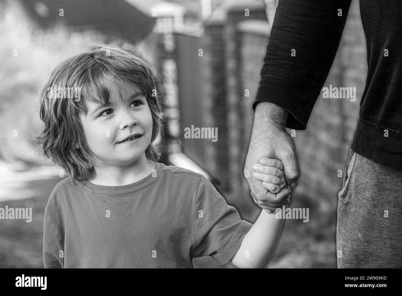 Father's hand lead his child son, trust family concept. Parents holds ...