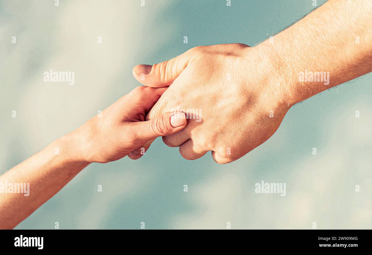 Lending a helping hand. Hands of man and woman reaching to each other ...