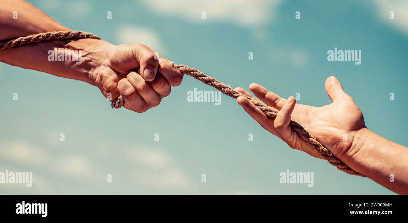 Rescue, help, helping gesture or hands. Conflict tug of war. Rope, cord. Hand holding a rope ...