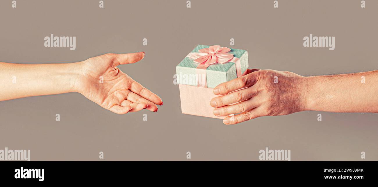 Gift box in hand, surprise and holiday concept. Man hands holding ...