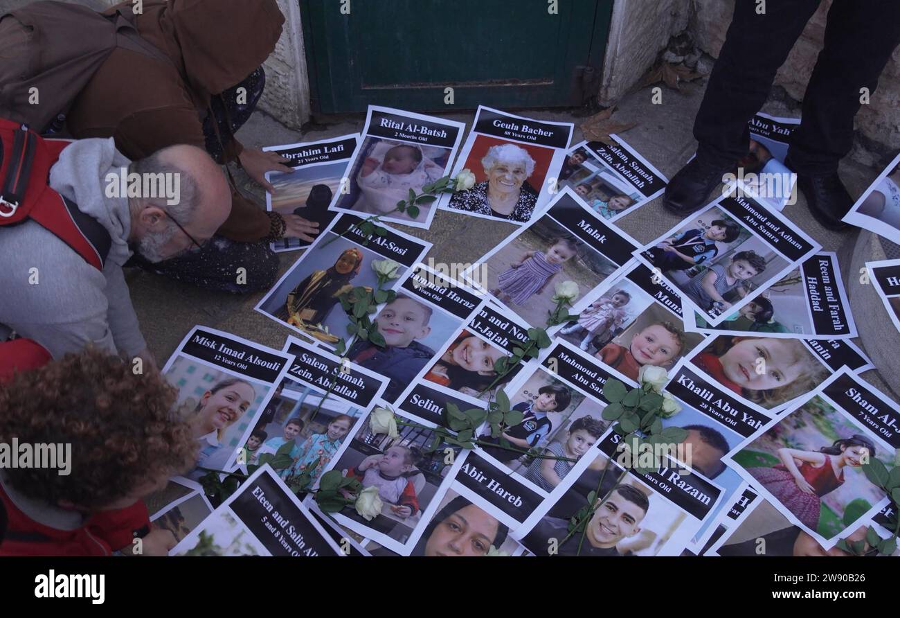 Israeli Jewish peace activists place flowers and posters with portraits ...