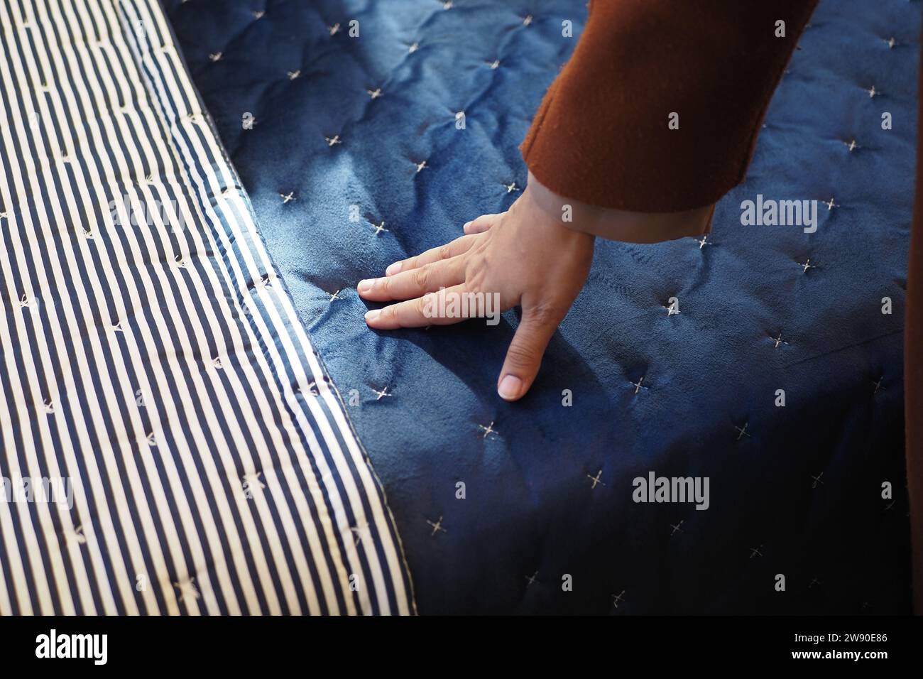 Hand touching and pressing orthopedic mattress on bed Stock Photo - Alamy