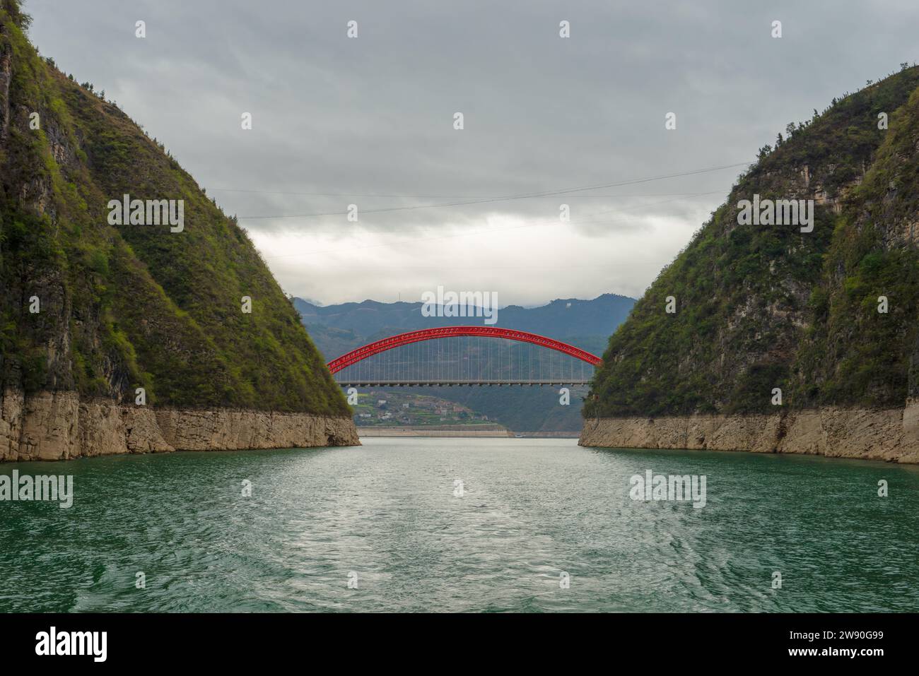 Under cloudy skies, a magnificent view of the Red Bridge in the steep ...