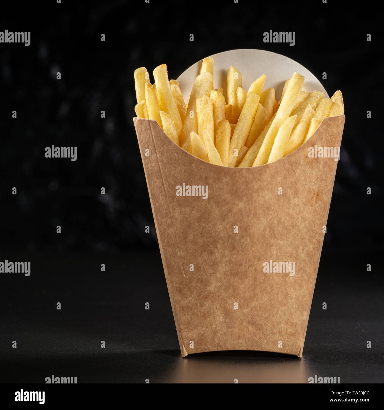 Large portion -French fries in a paper basket. Fast food.French fries ...