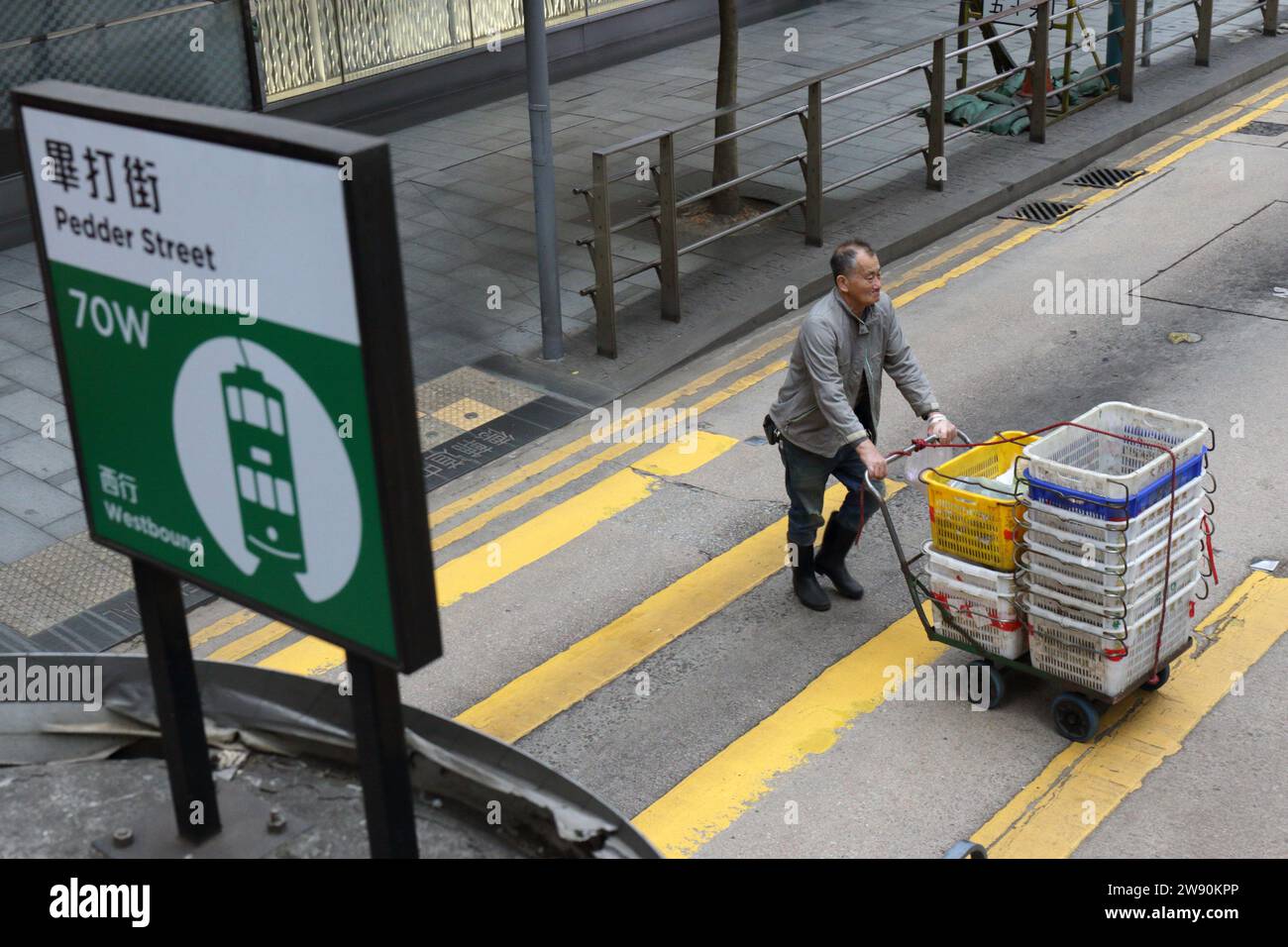 Man pushing handcart crossing Pedder Street, Central District, Hong ...