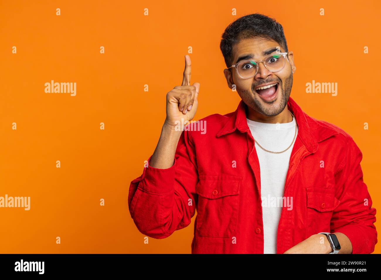 Eureka. Inspired Indian man pointing finger up with open mouth, having ...