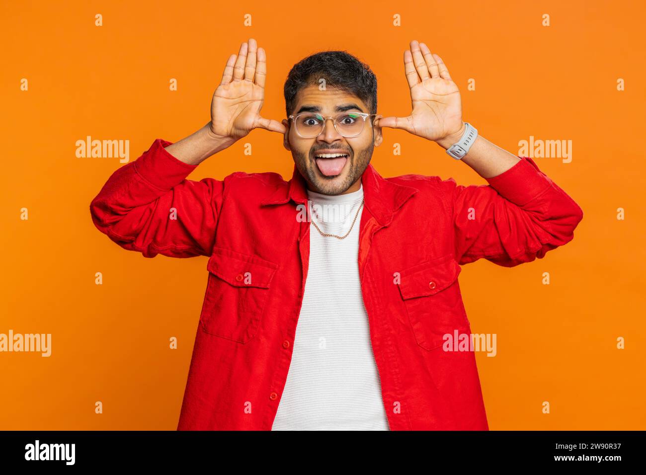 Funny comical playful Indian man making silly facial expressions ...