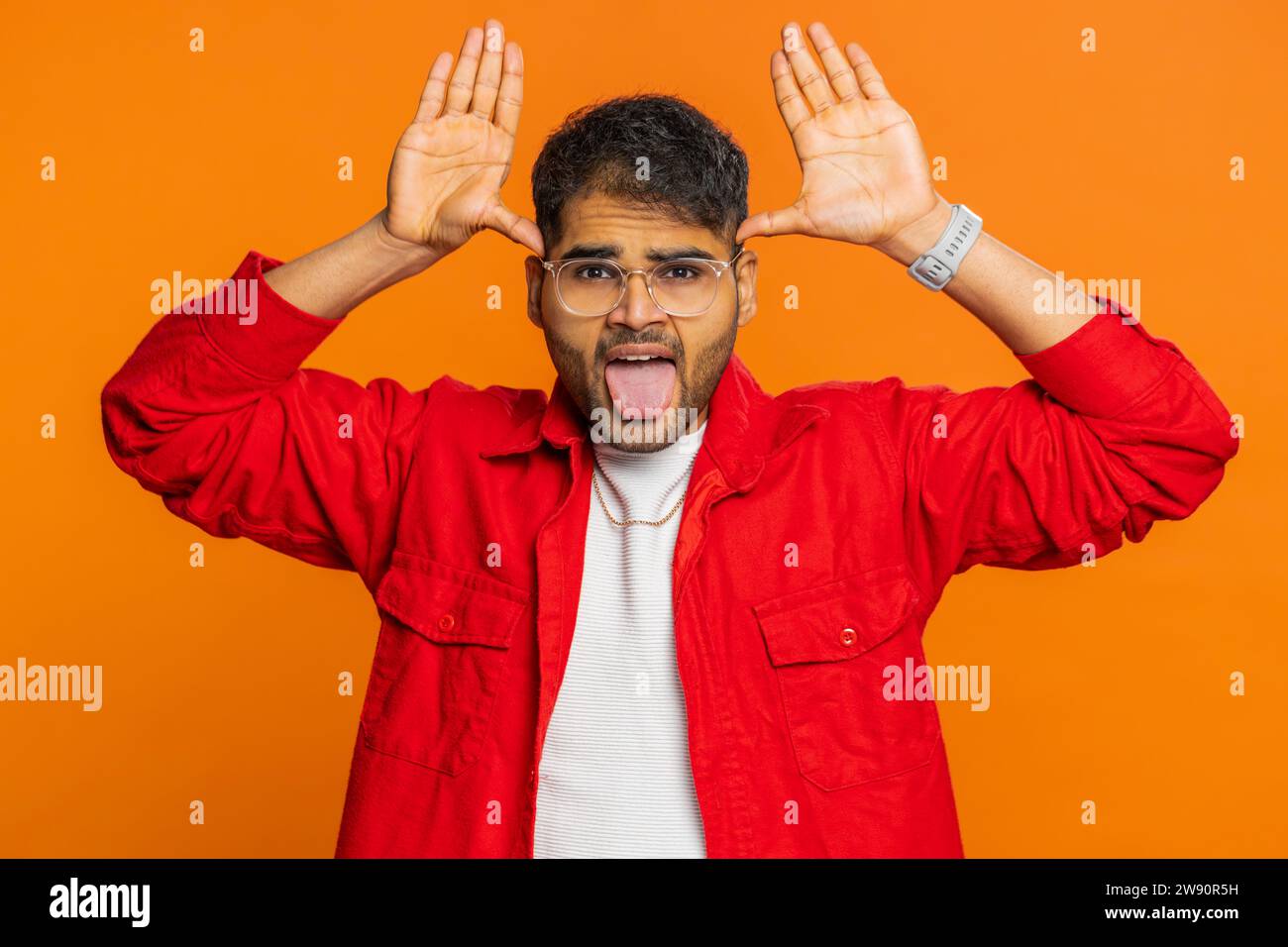 Displeased Indian Man Showing Tongue Making Faces At Camera Fooling