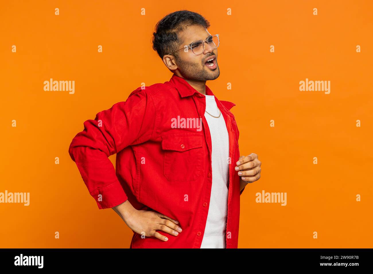 Indian man suffering backache, massaging sore place lower spine ...