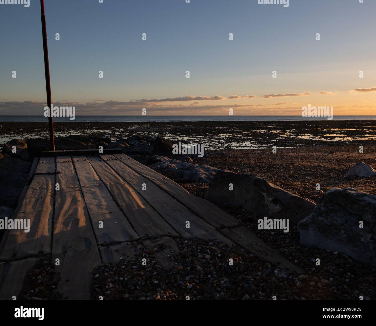 Sunset at Worthing beach featuring a storm drain, West Sussex, UK Stock ...