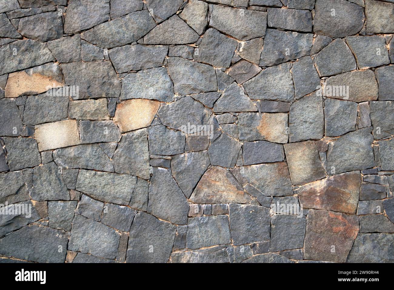 yellow beige natural stone wall of different sized stones, traditional ...