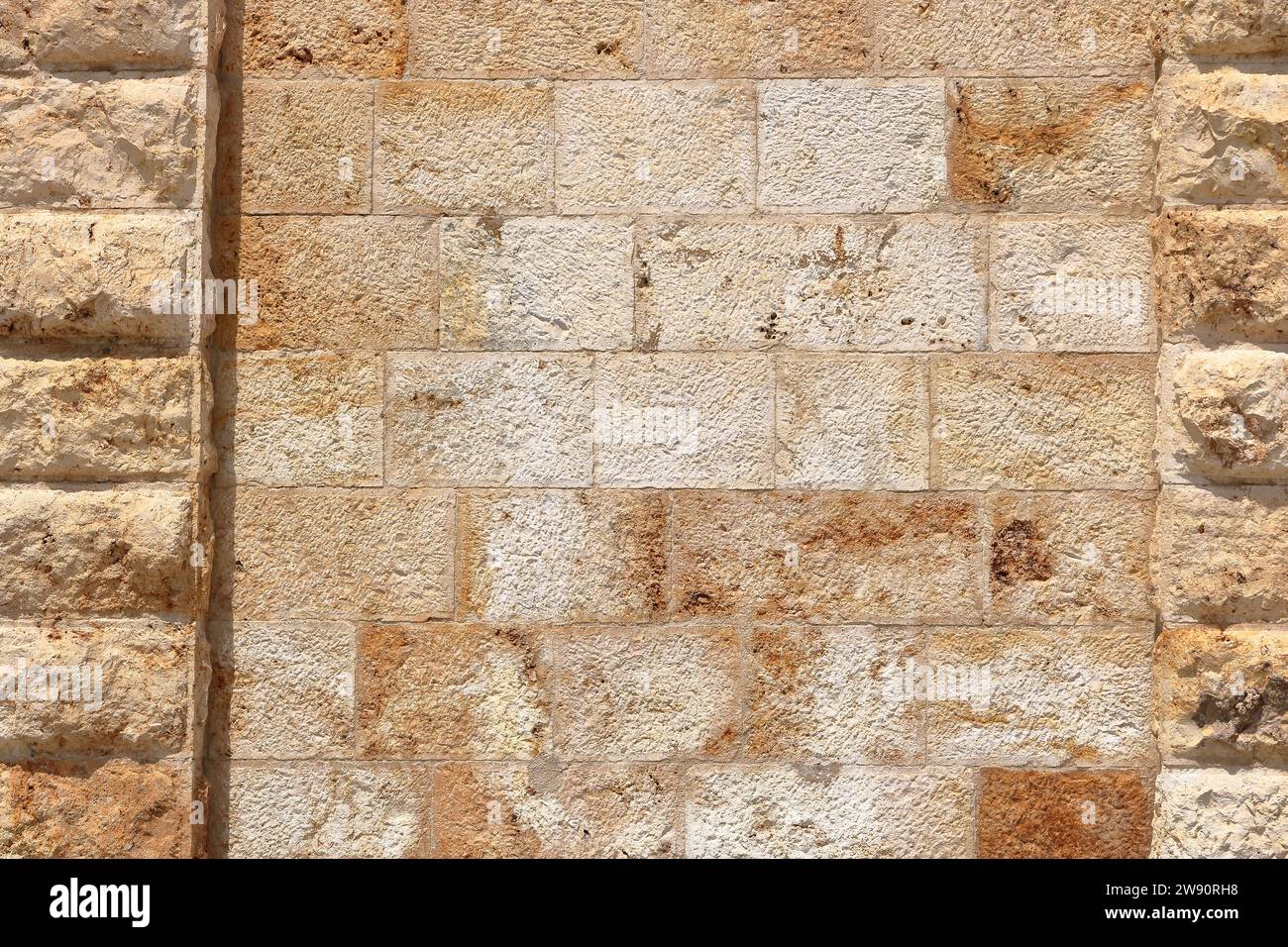 yellow beige natural stone wall of different sized stones, traditional ...