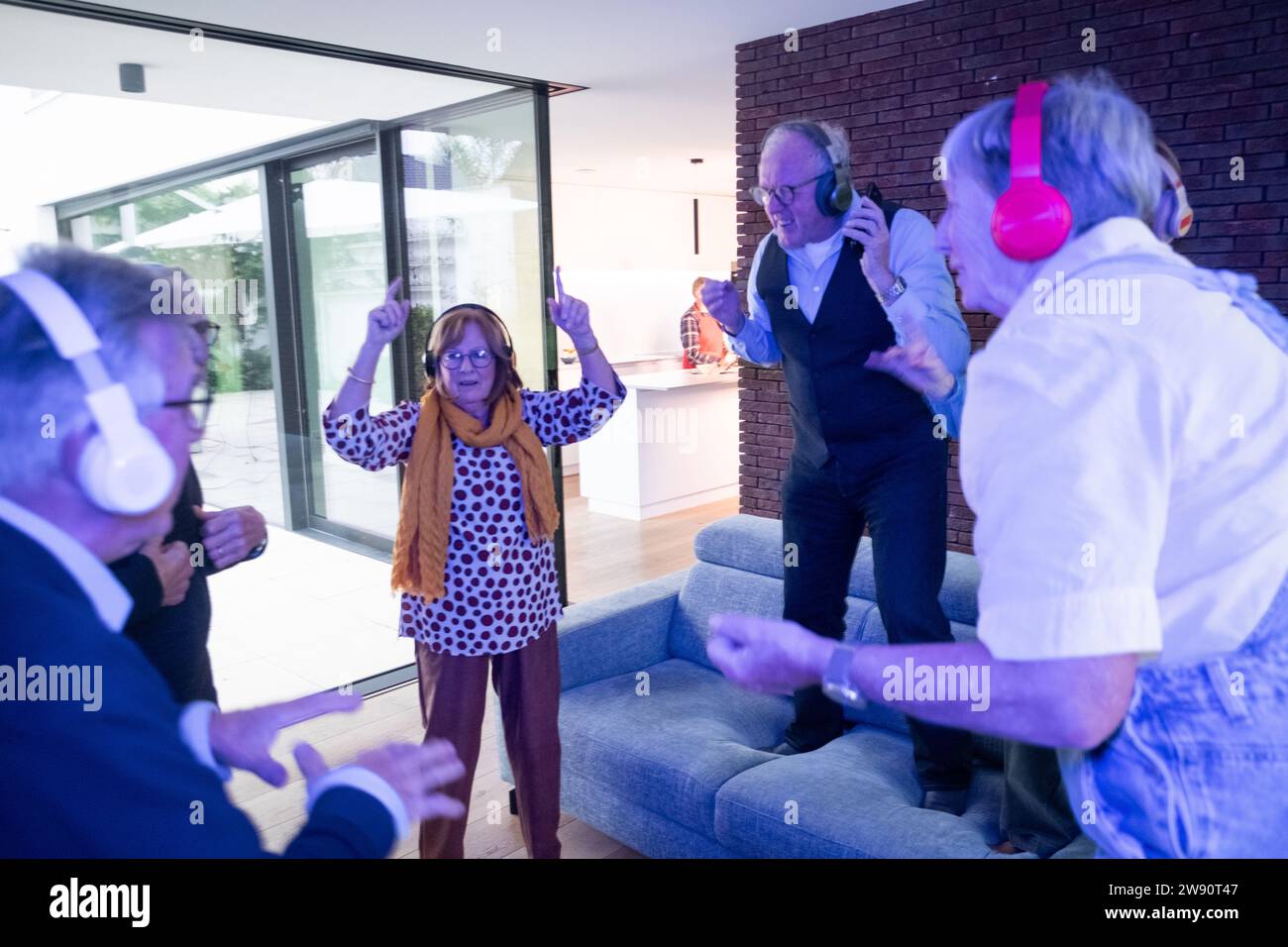 A group of energetic seniors is captured mid-dance, each wearing ...
