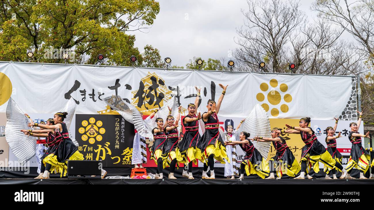 Japanese young women Yosakoi dance team in black and yellow costumes on ...