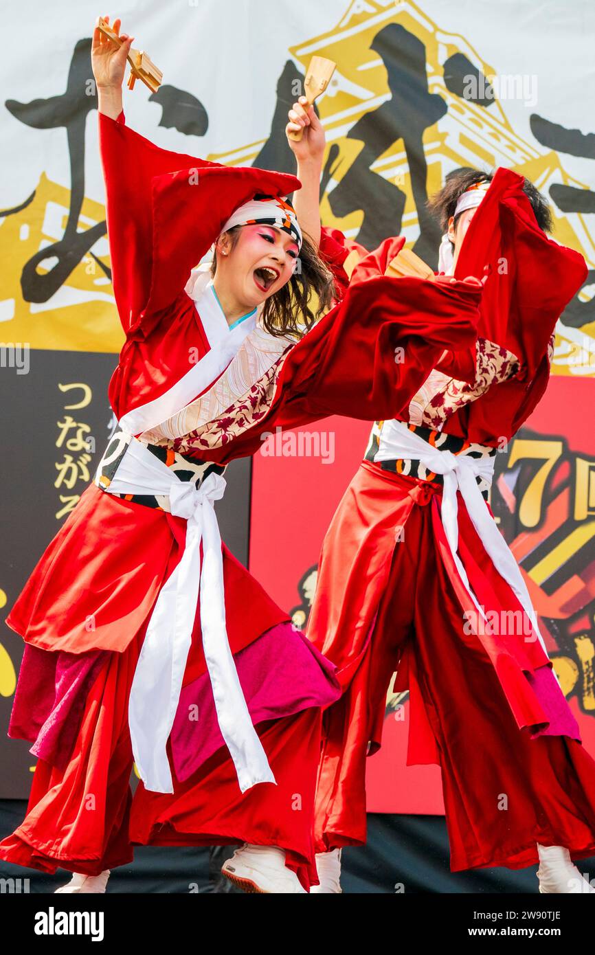 Close up, young Japanese woman and man yosakoi dancers on stage dancing ...