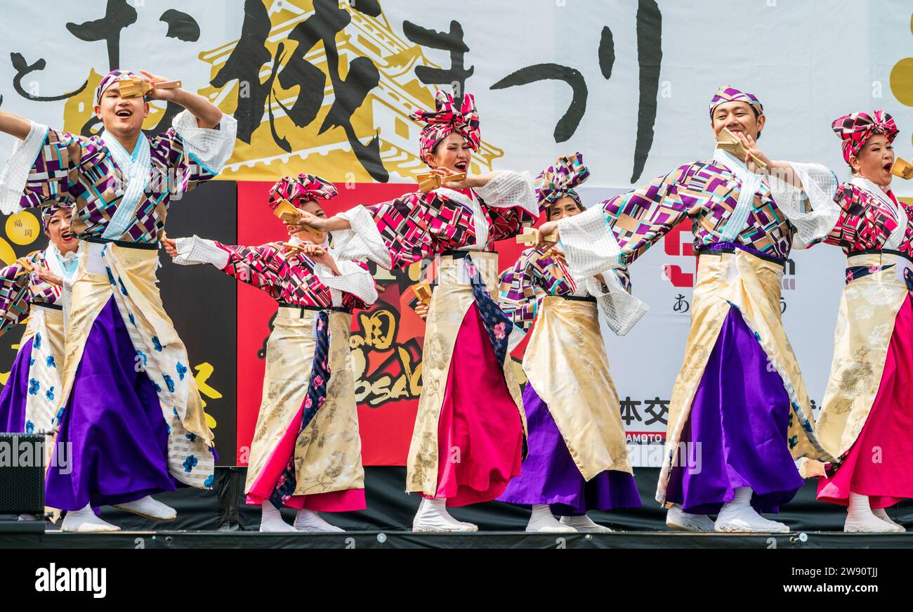 Japanese Yosakoi dance team in colourful yukata tunics on stage dancing ...
