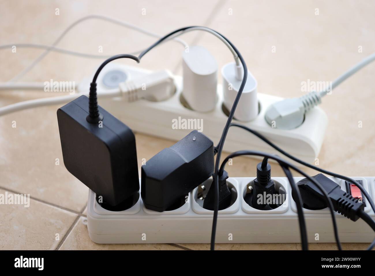 Overloaded power boards. Power strips with different electrical plugs ...