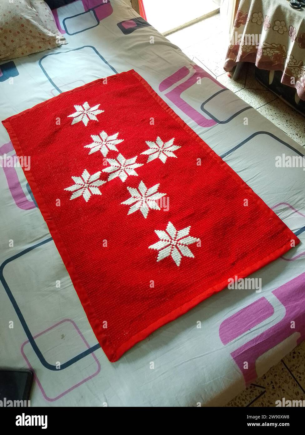 A red handmade mat on the surface Stock Photo - Alamy