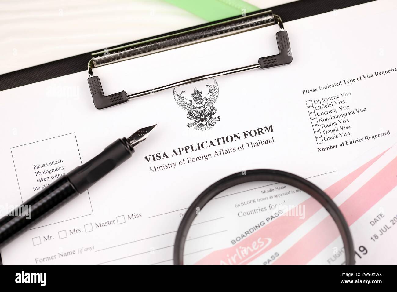 Thailand Visa application form on A4 tablet lies on office table with ...