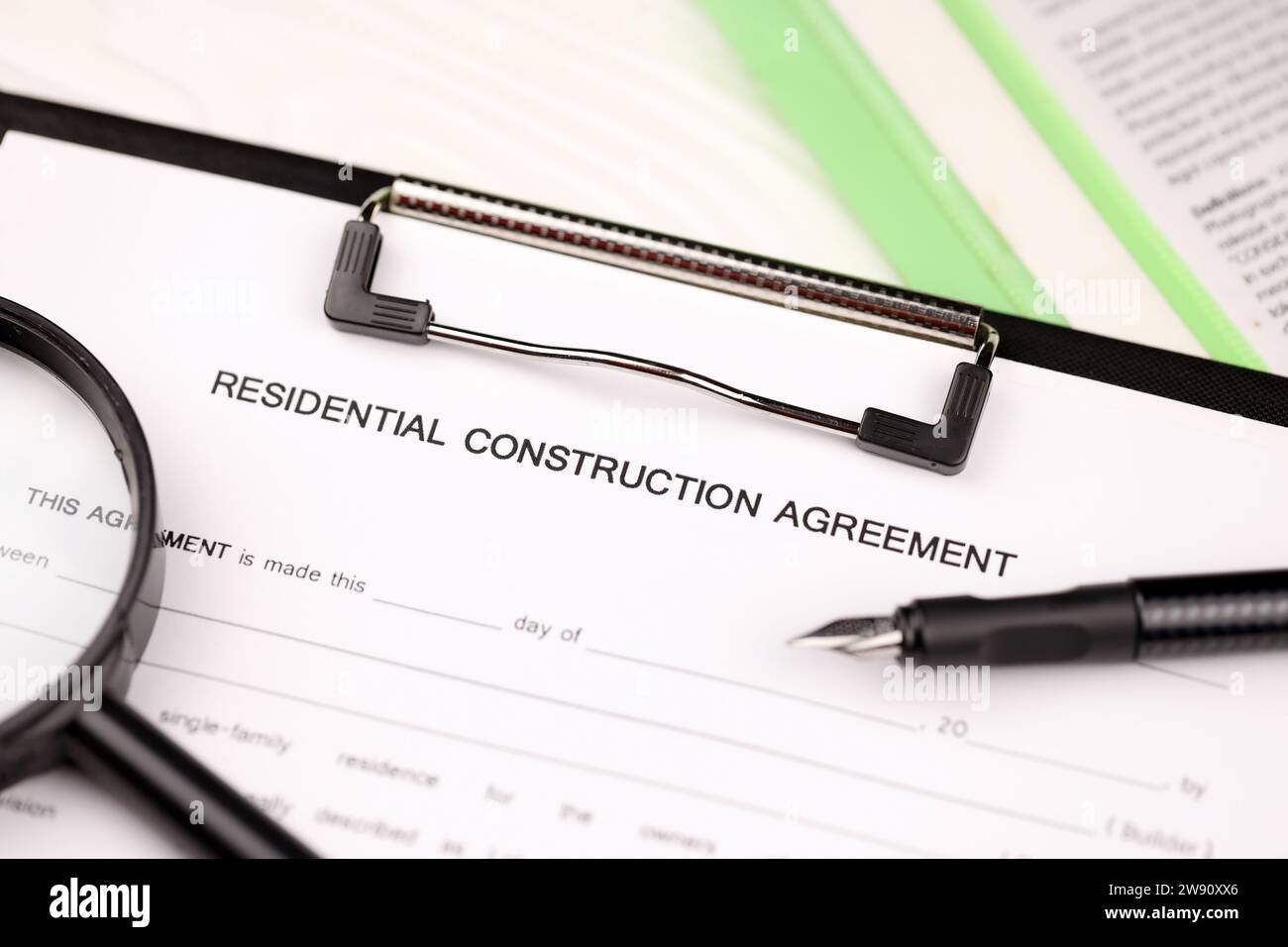 Construction contract form on A4 tablet lies on office table with pen ...